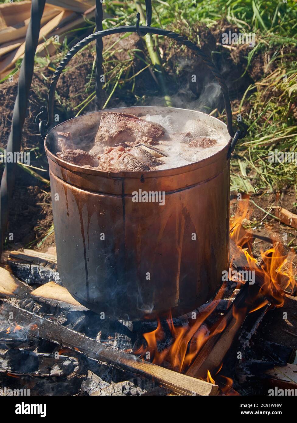 Cooking meat for in the kettle medieval dinner, Festival of historical ...