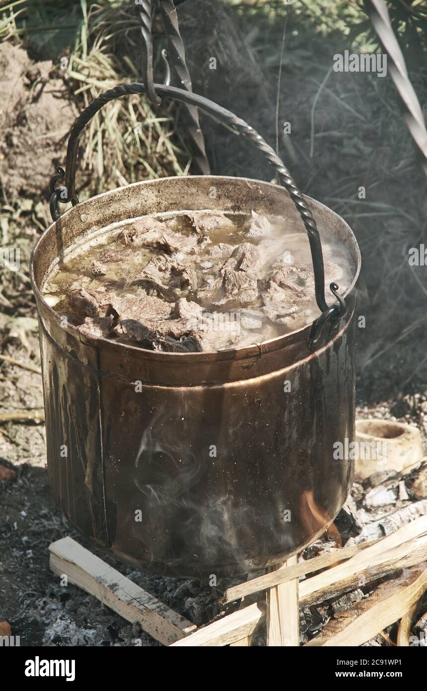 Cooking meat for in the kettle medieval dinner, Festival of historical ...