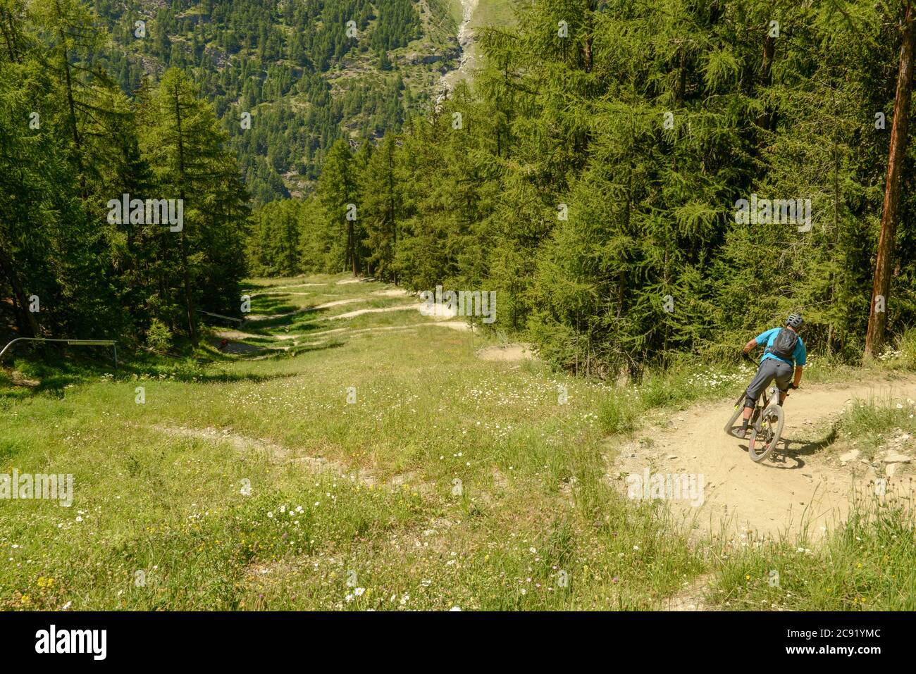 Zermatt, Switzerland - 19 July 2020: people driving a mtb on a flow ...