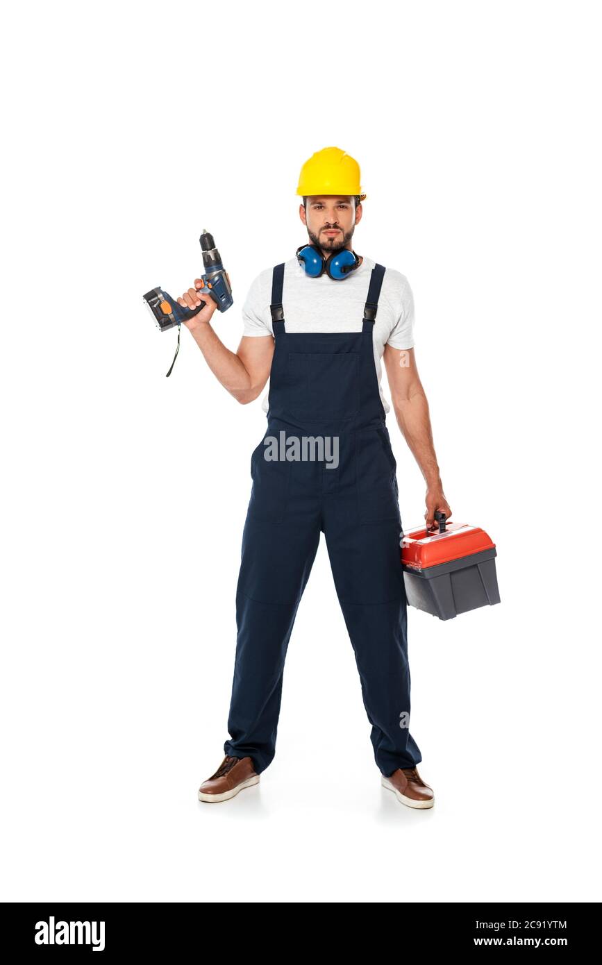 Handsome workman in uniform and hardhat holding electric screwdriver ...