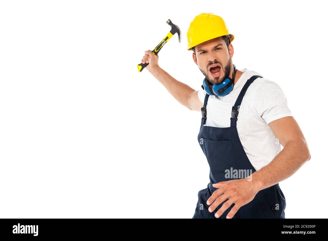 Angry workman in uniform and hardhat screaming while holding hammer ...