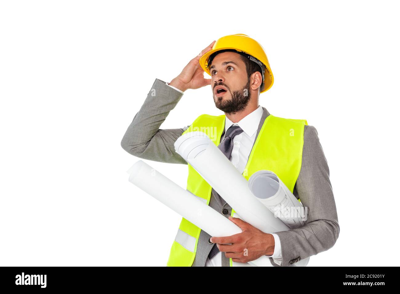 Shocked engineer in suit holding blueprints and looking away isolated ...
