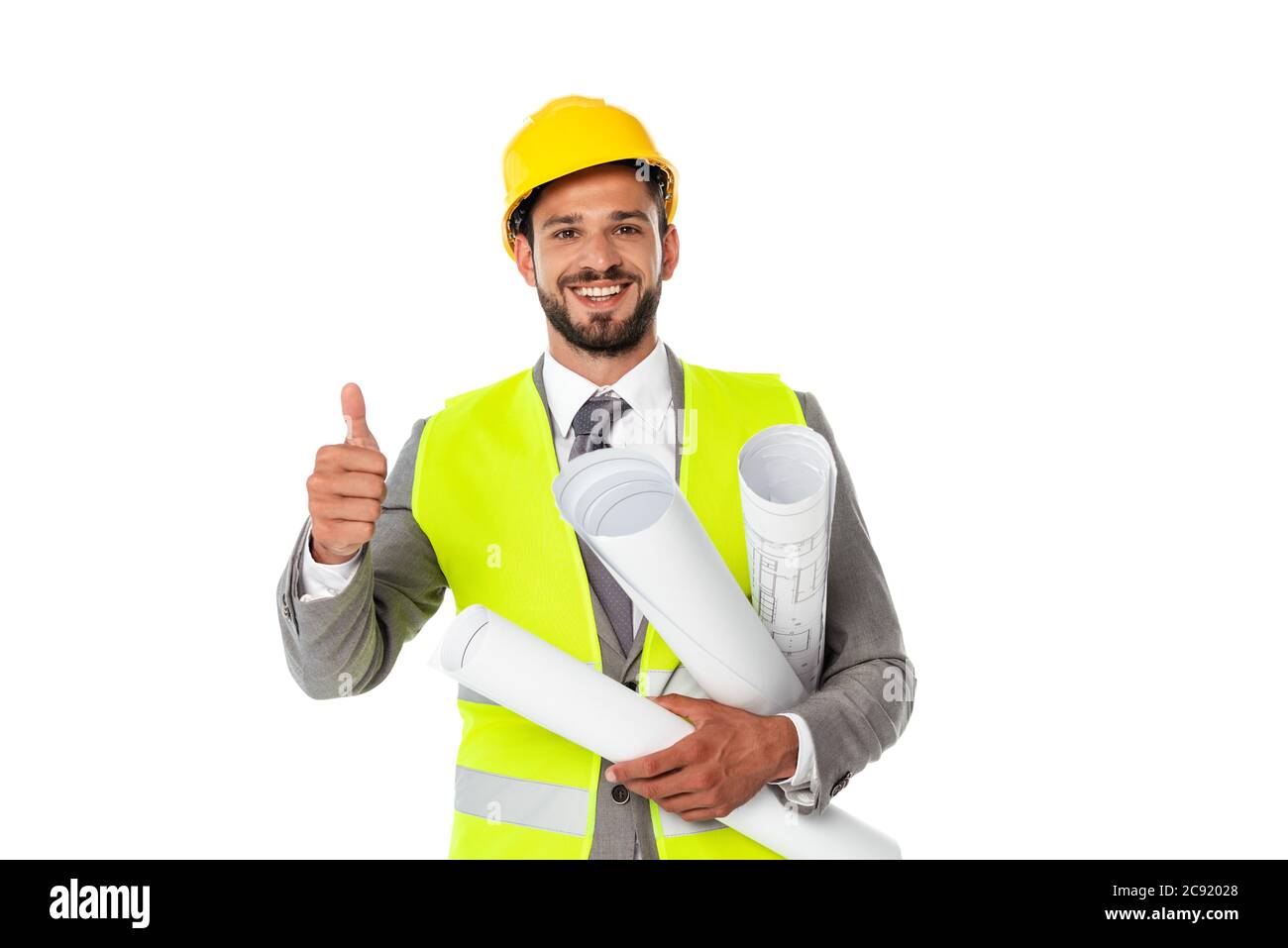 Handsome engineer showing thumb up while holding blueprints and smiling ...