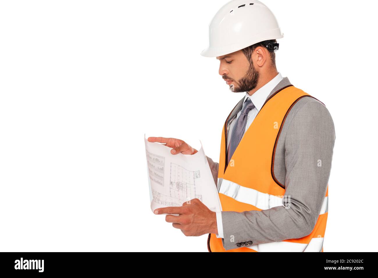 Engineer in safety helmet and suit looking at blueprint isolated on ...