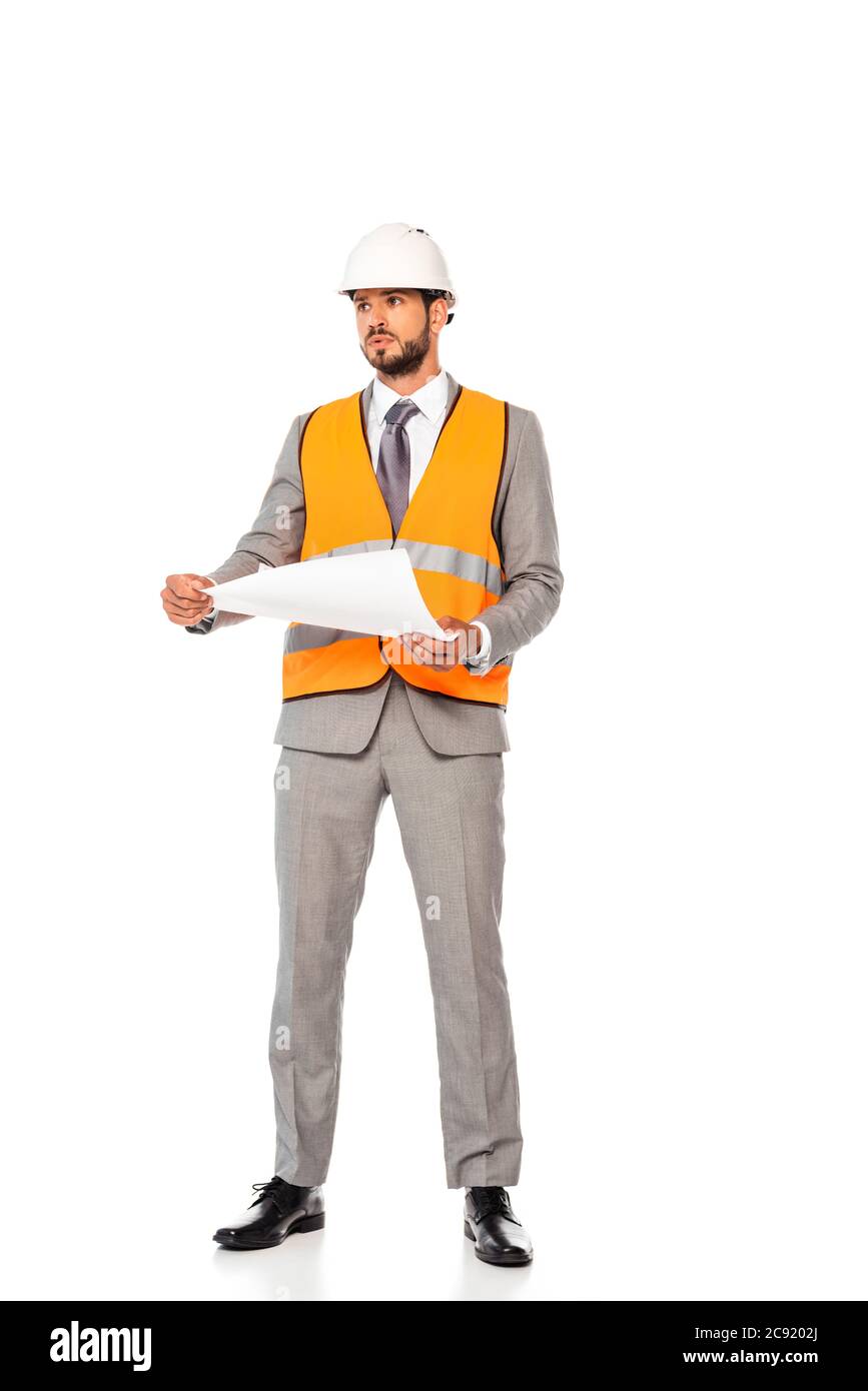 Handsome engineer in suit and hardhat holding blueprint on white ...