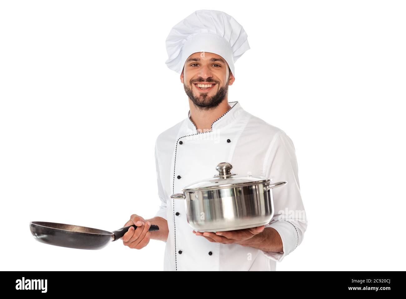 Smiling chef in uniform holding pan and frying pan isolated on white ...