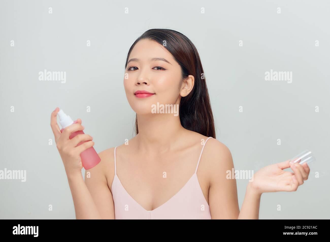 Beautiful woman face spray on face lotion cosmetology on white ...