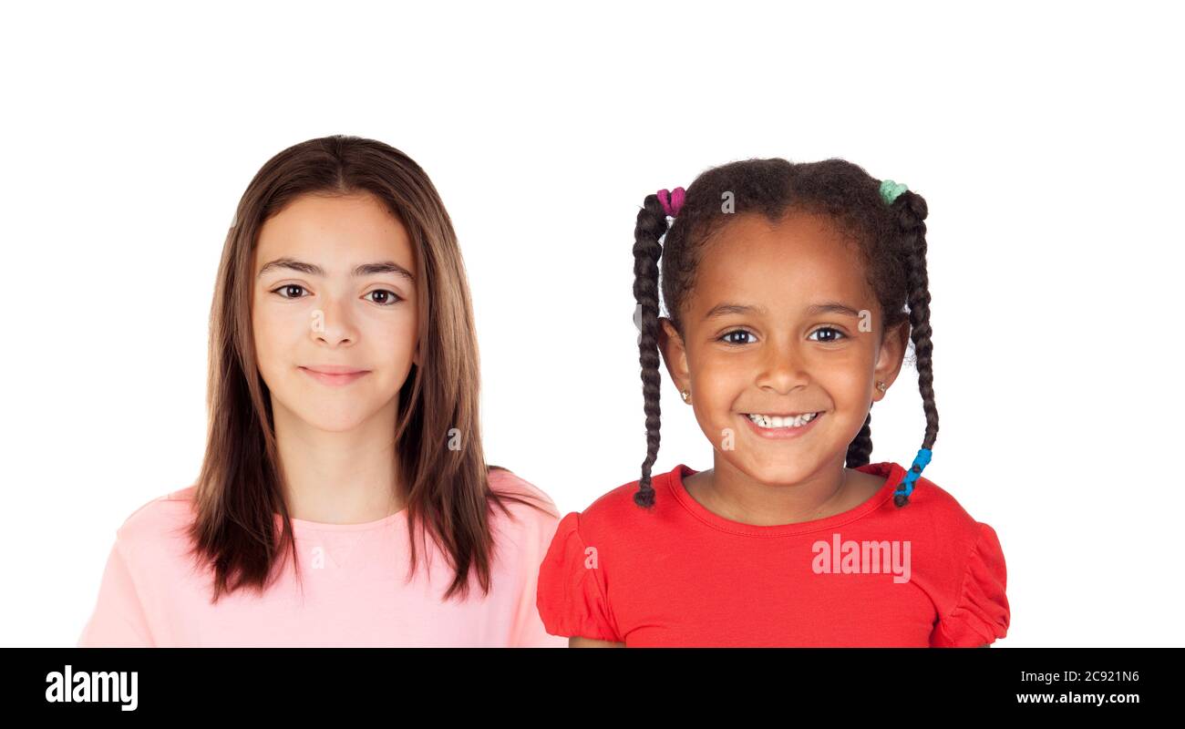 Two beautiful girls of different races looking at camera isolated on a ...