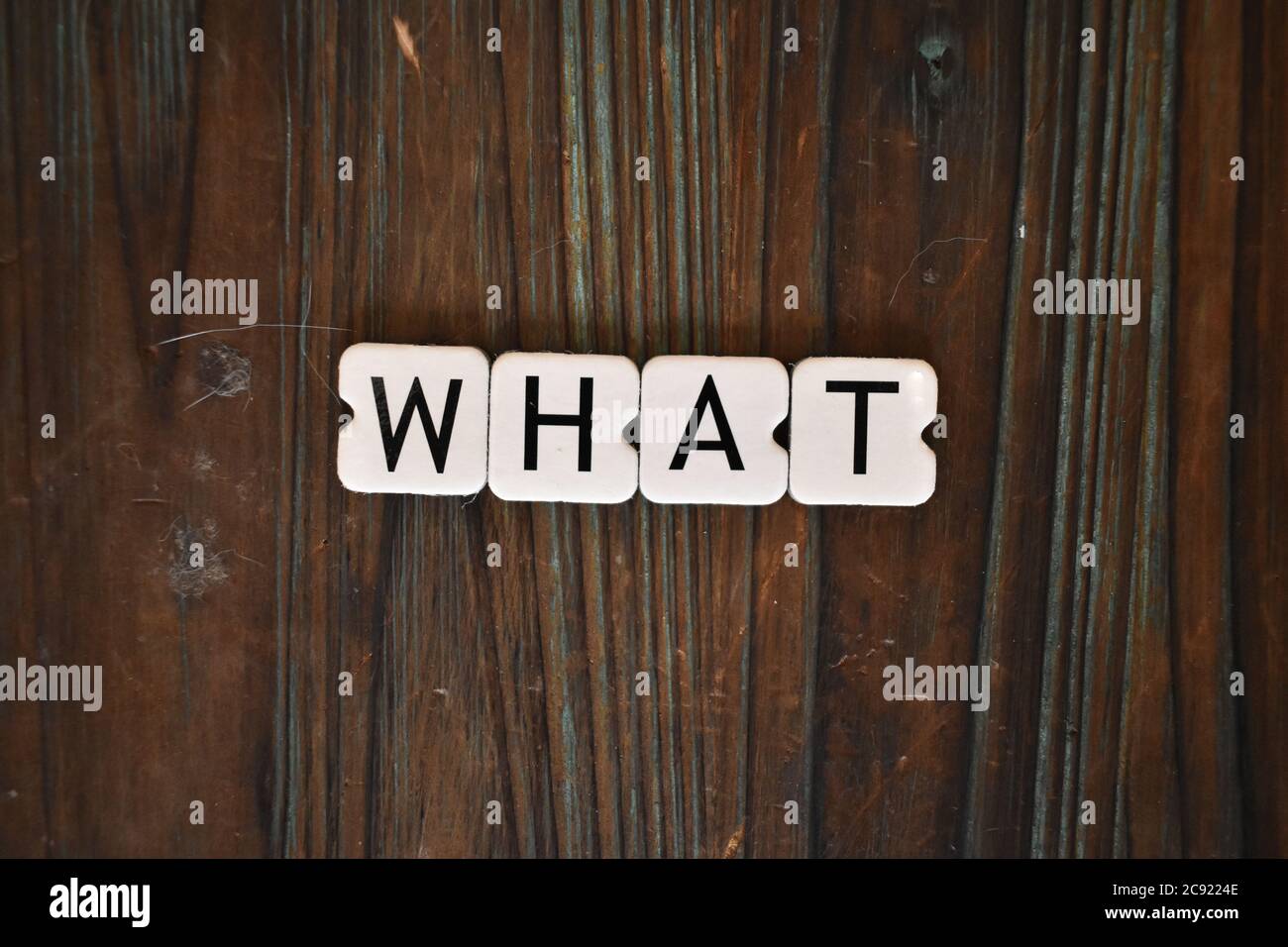 Word What written with white plastic letters on a wooden surface Stock ...