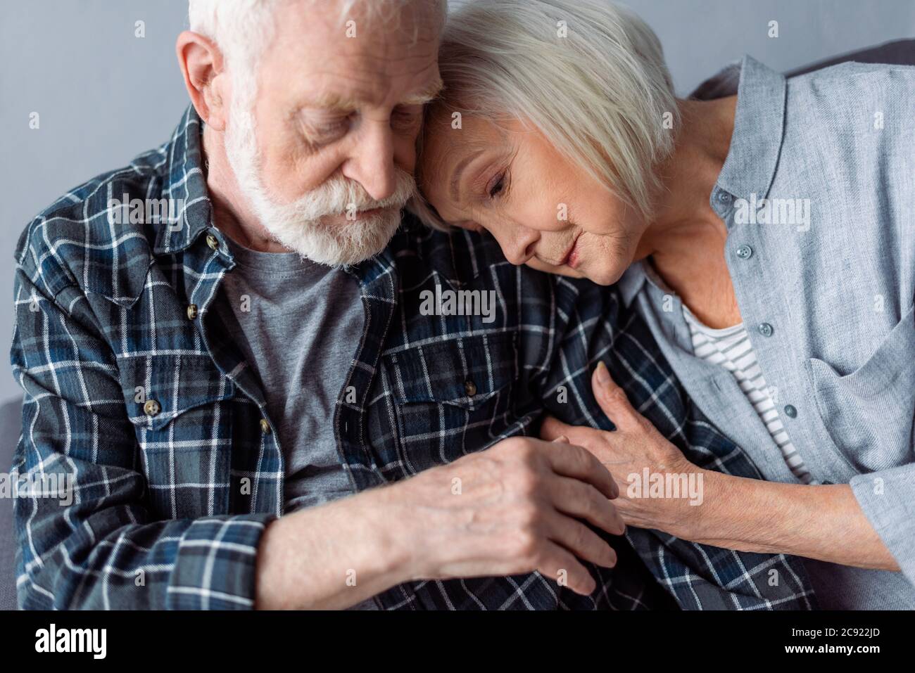 senior woman hugging and leaning on old man with dementia disease Stock ...