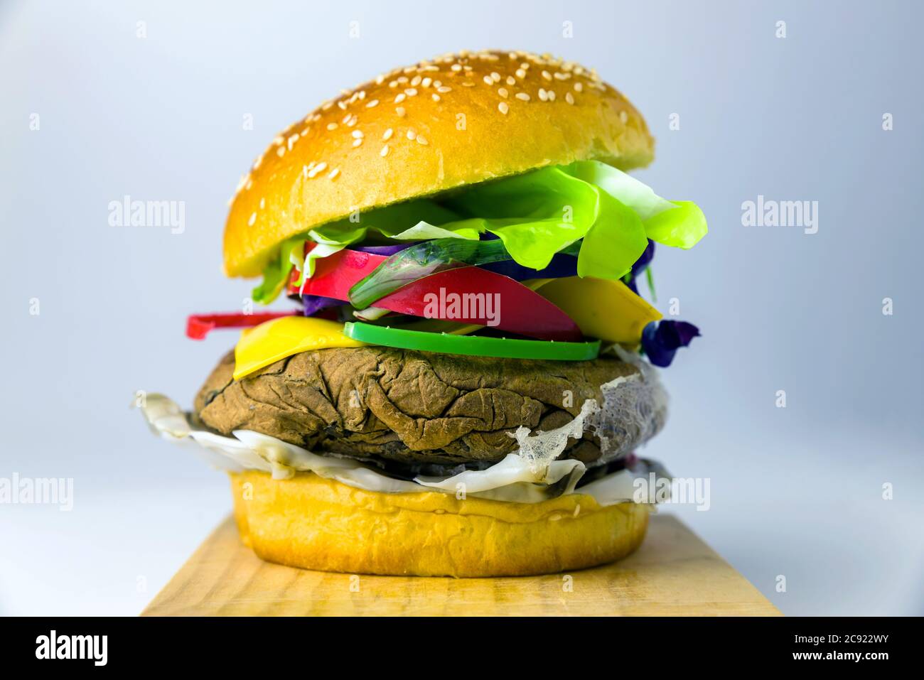 Burger filled with plastic waste and paper cardboard. Recycled waste in ...