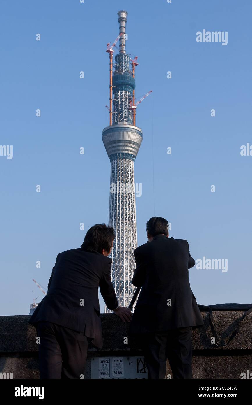 Men looking at the Tokyo SkyTree under construction in Japan.Tokyo Sky ...