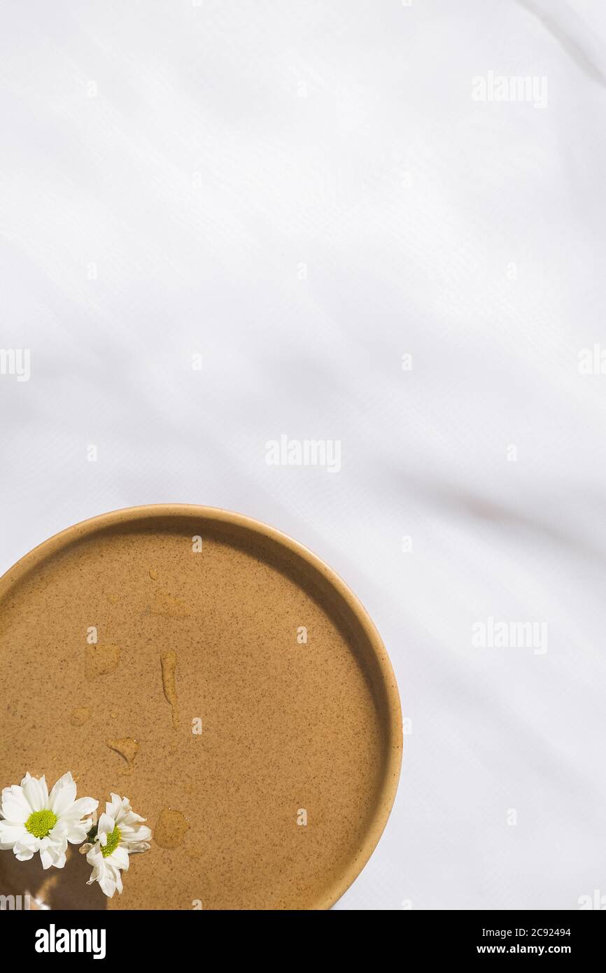 Top view of white flowers in a plate in voile fabric background Stock ...