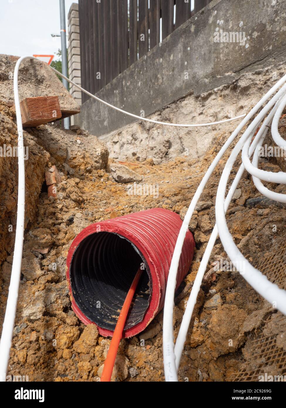 Cables sticking out of the ribbed safety tube in the street, detail of ...