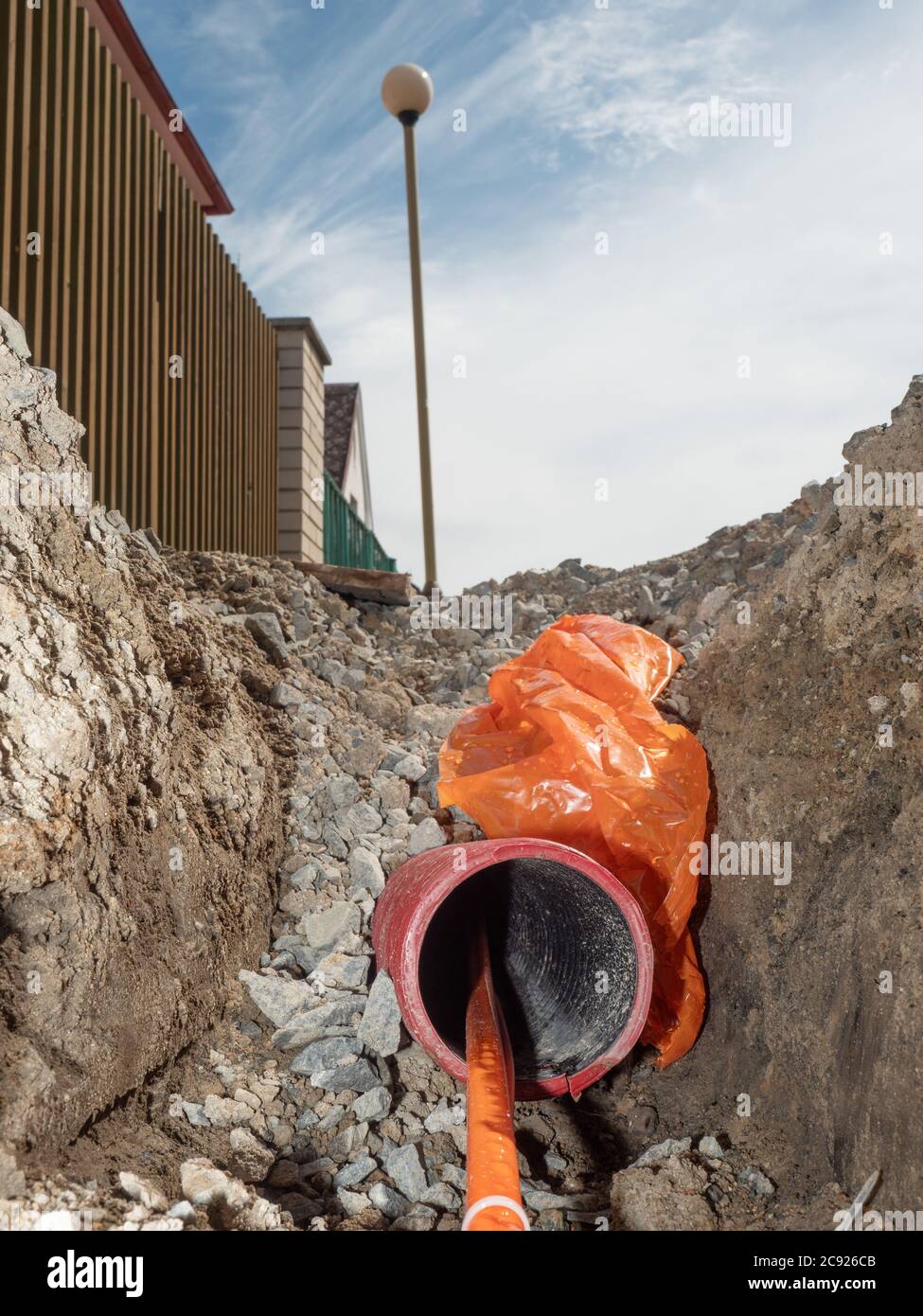 Detail of optic fiber wire in ribbed flexible red plastic tube, thin ...