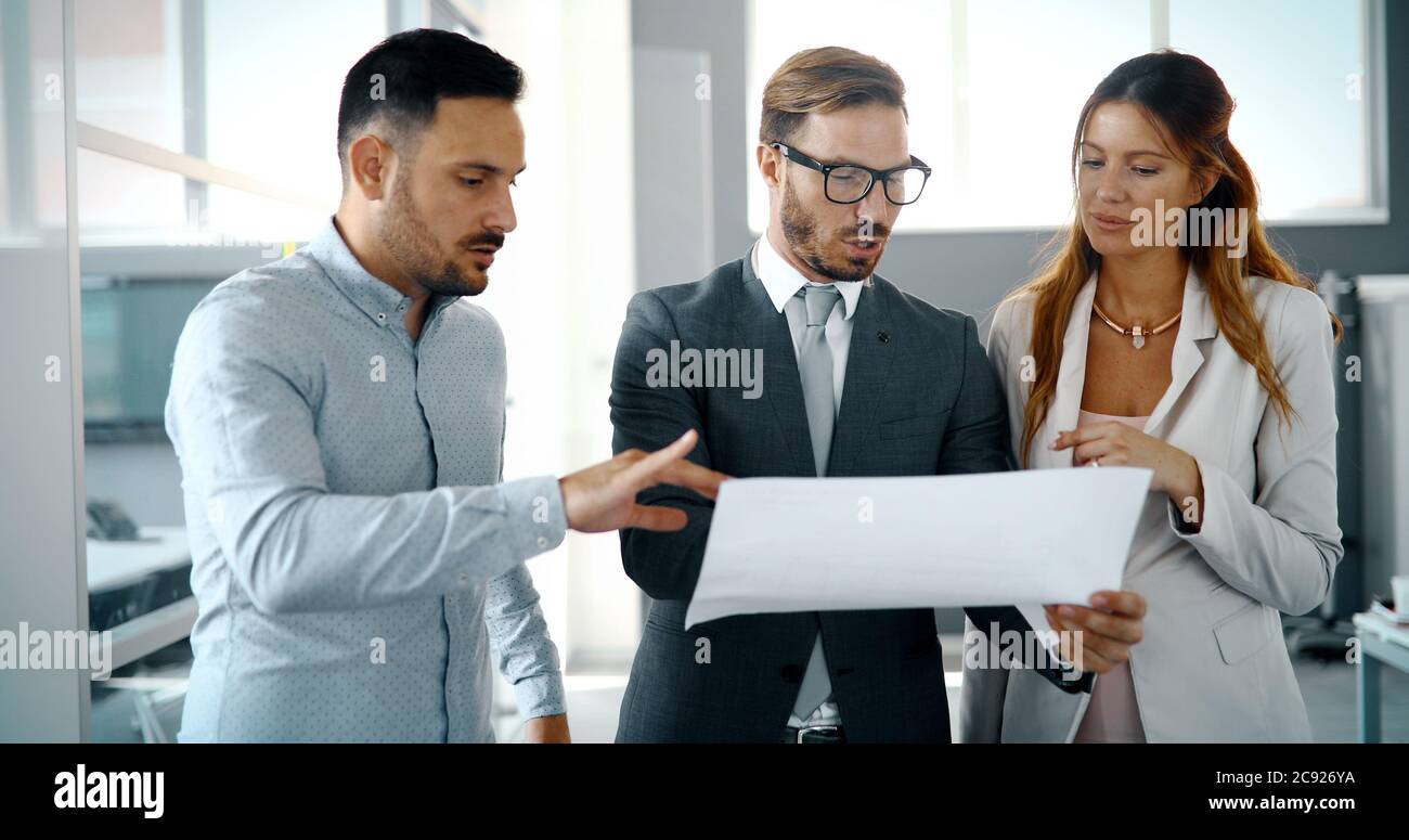 Business colleagues collaborating and discussing project plans Stock ...