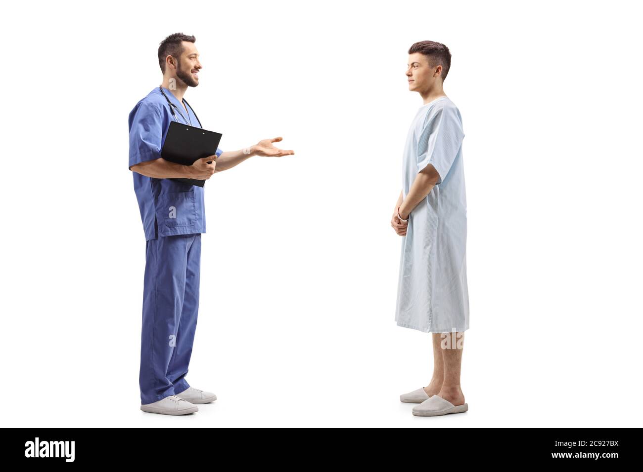 Full length profile shot of a male patient in a hospital gown listening ...