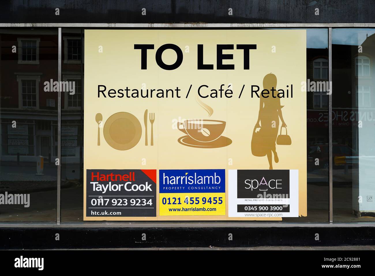 Close up window of another empty shop, retail unit displaying 'To Let ...
