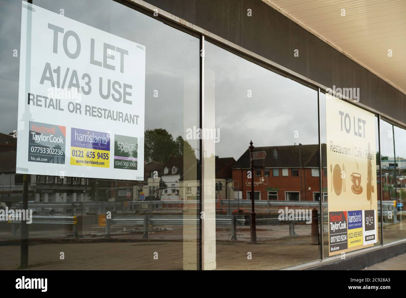 Close up window of another empty shop, retail unit displaying 'To Let ...