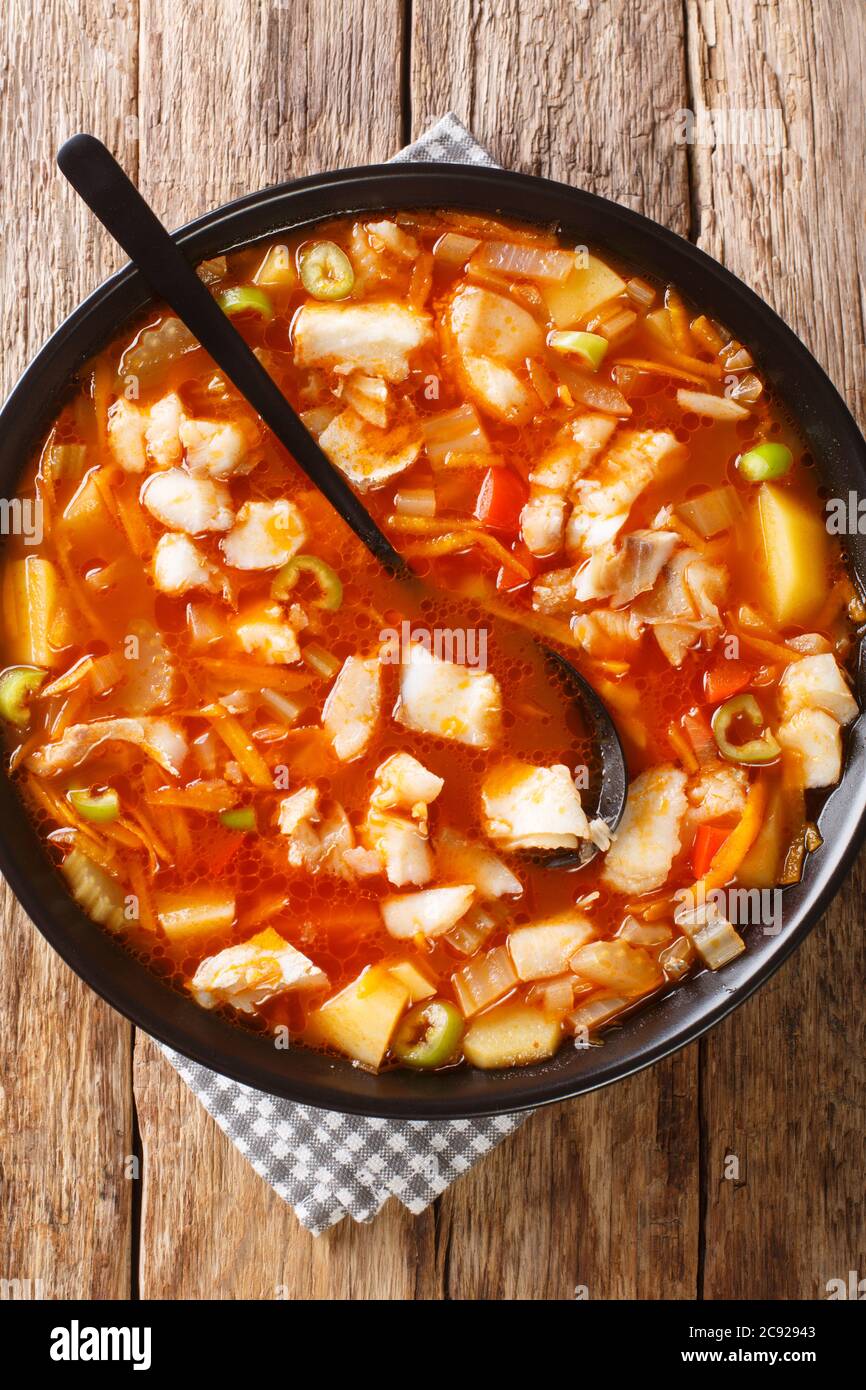 Bermuda Fish Chowder closeup in the plate on the table. Vertical top ...