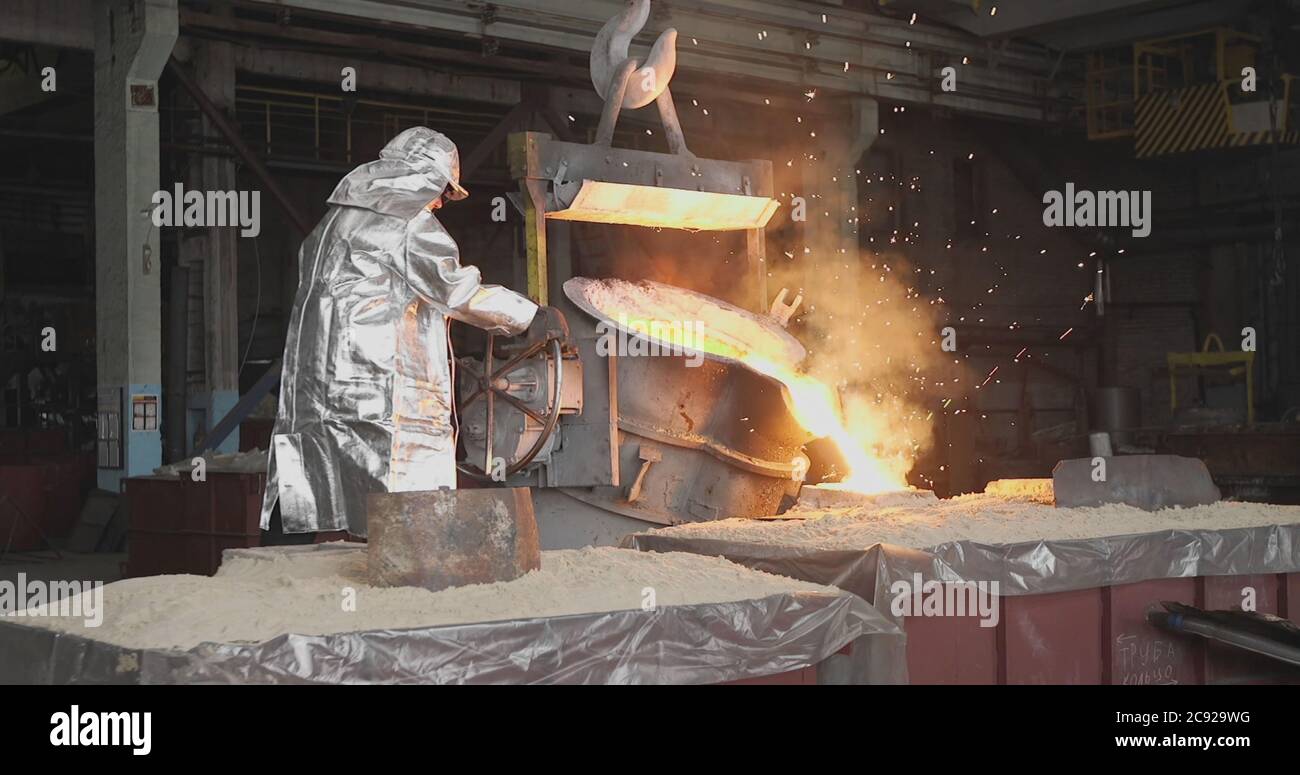 Smelting orange metal in a metallurgical plant. Liquid iron from the ...