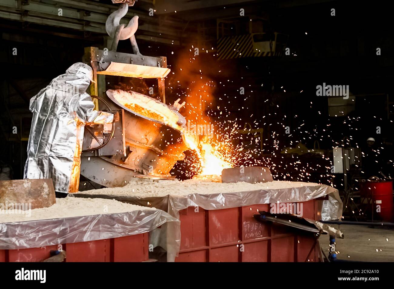 Smelting orange metal in a metallurgical plant. Liquid iron Stock Photo ...