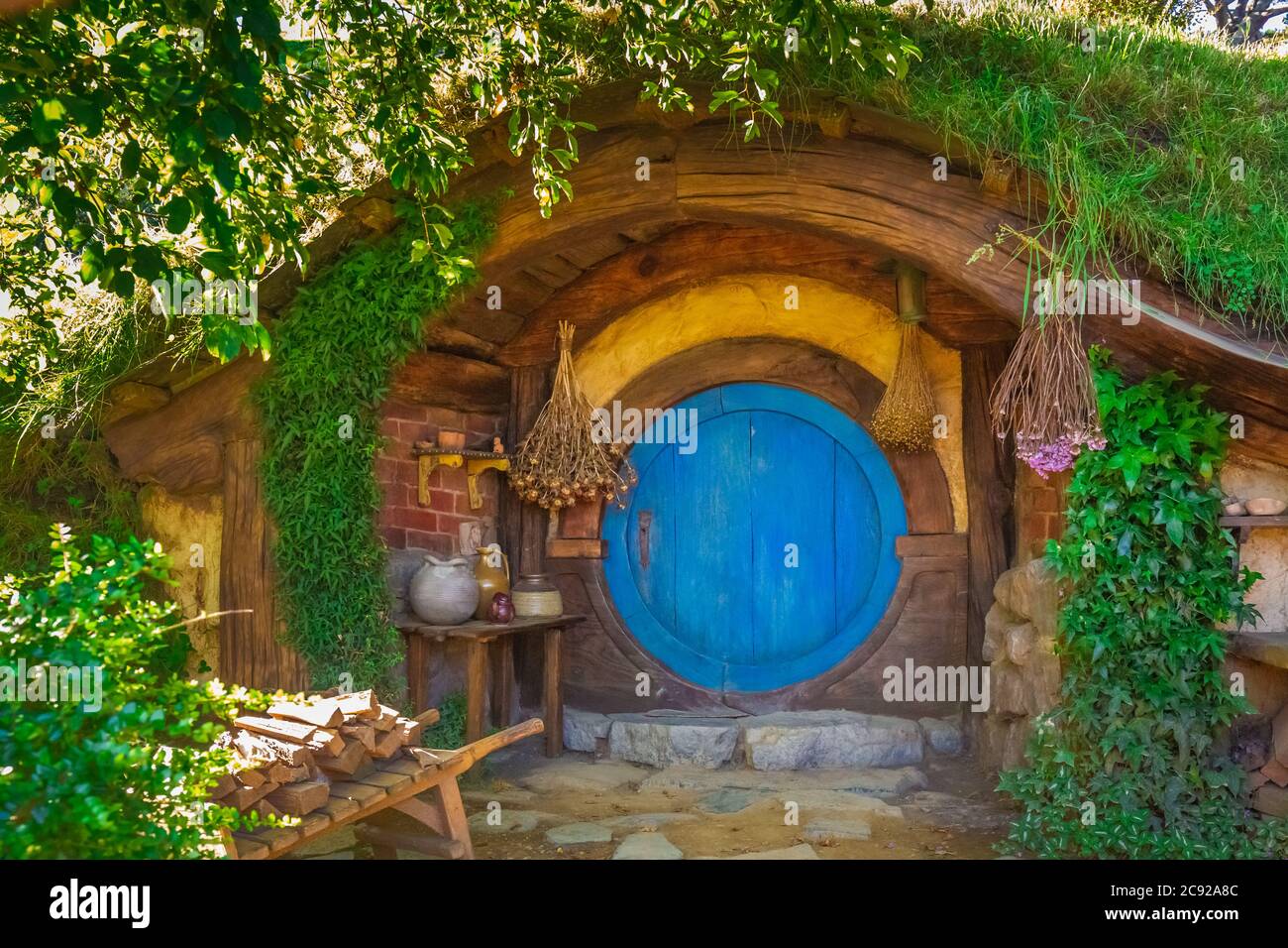 Entrance to the house with round door at the Hobbiton, New Zealand. The ...