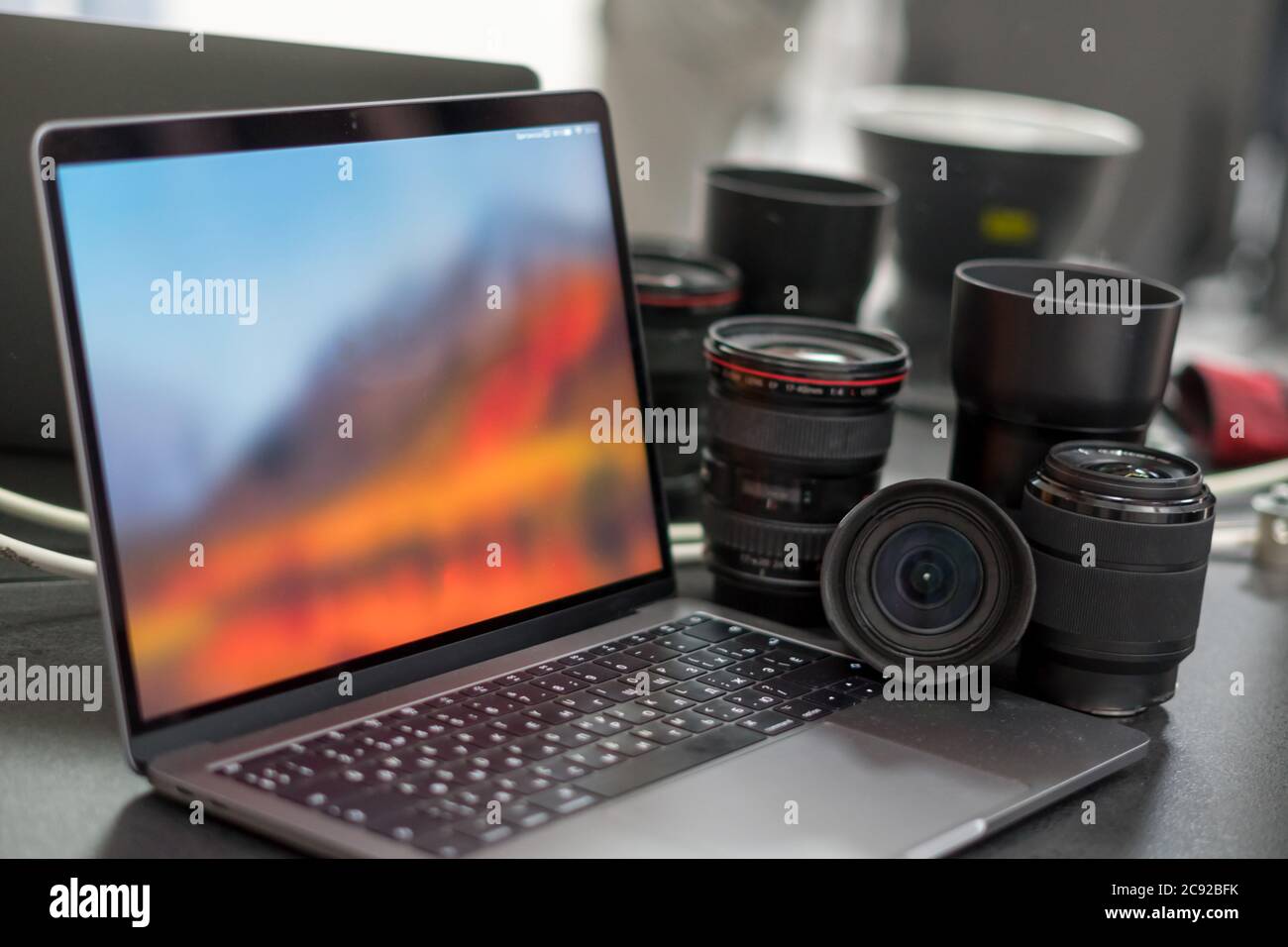 Digital camera, lens and laptop. concept of photographer work station ...