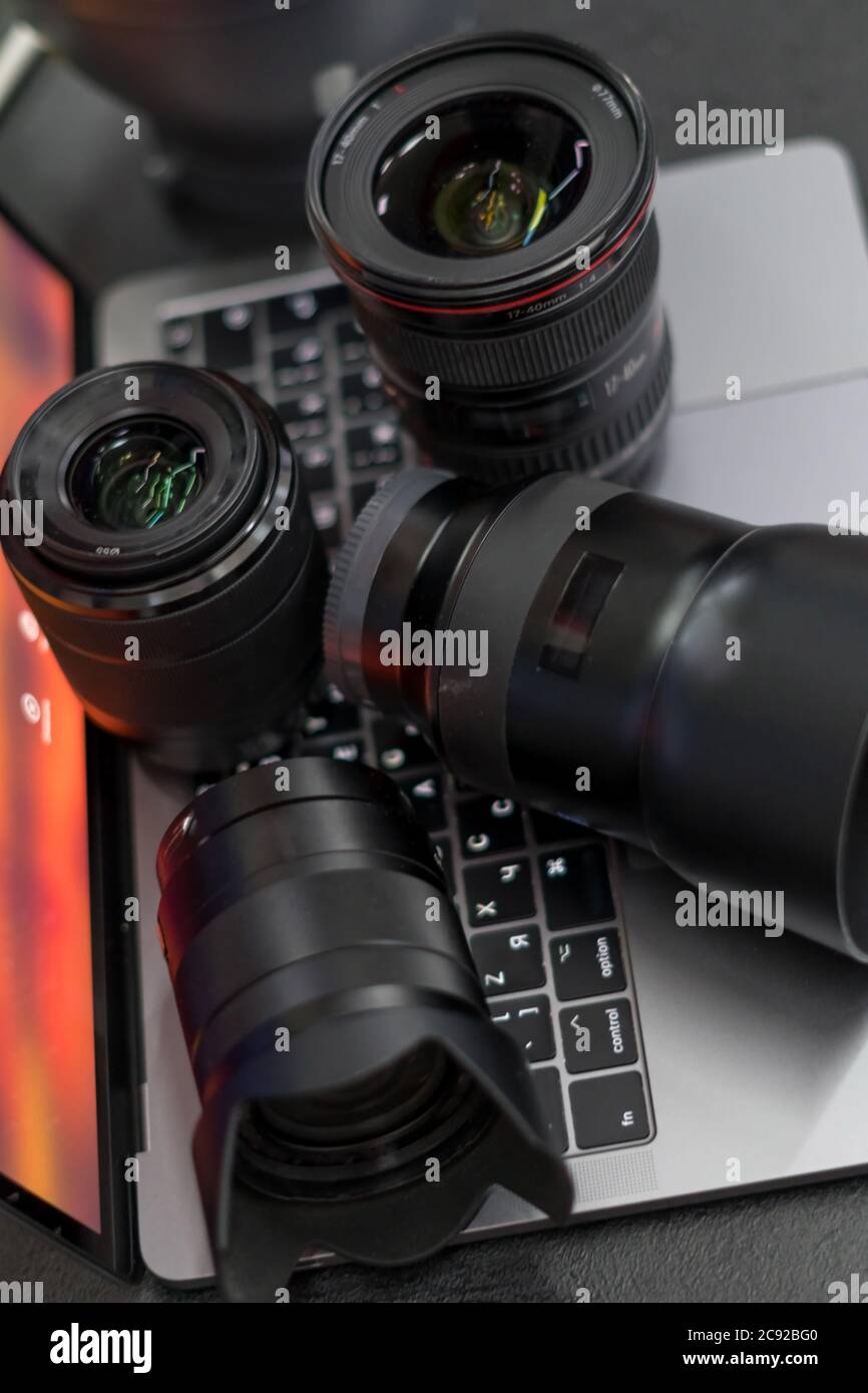Digital camera, lens and laptop. concept of photographer work station ...