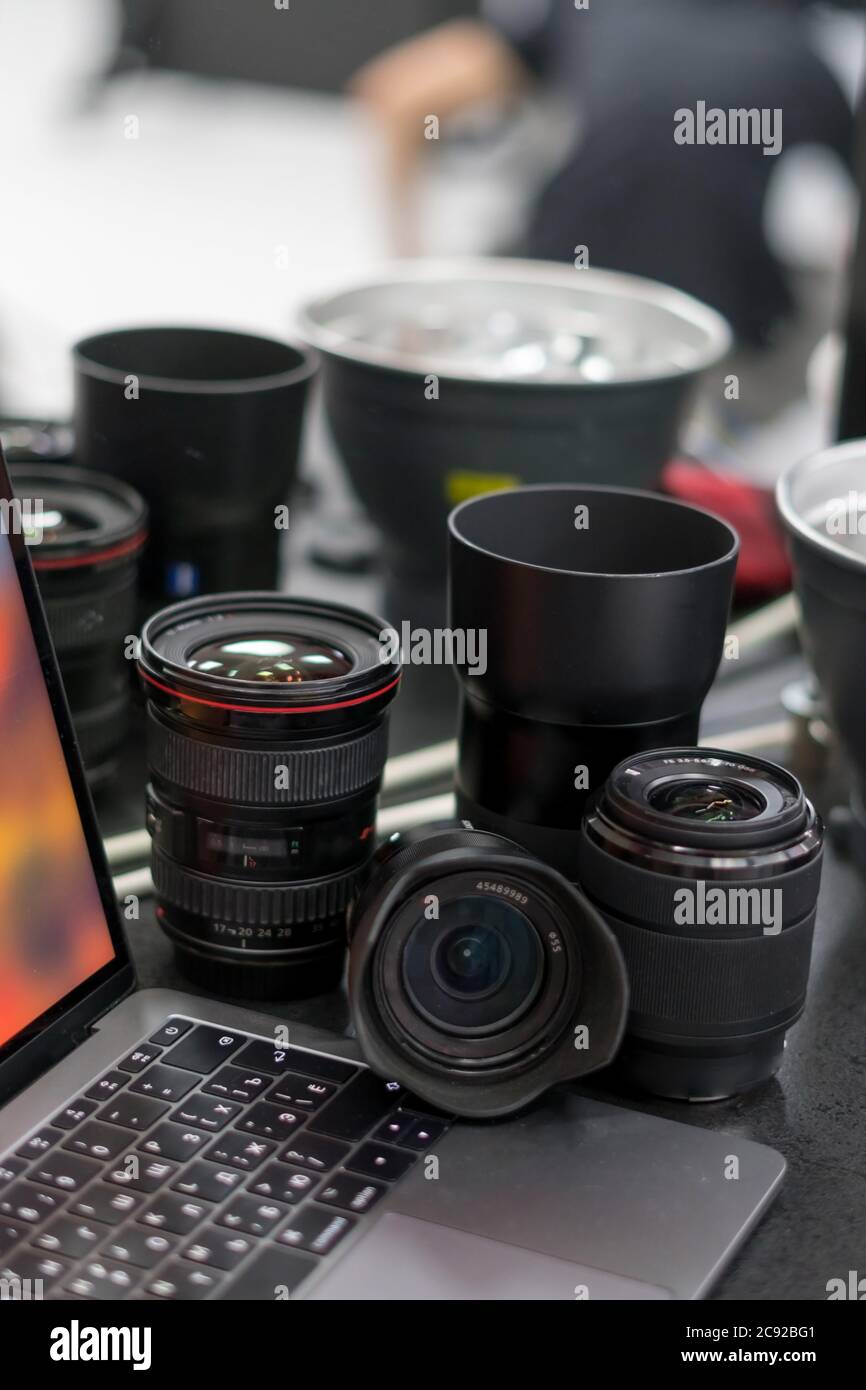 Digital camera, lens and laptop. concept of photographer work station ...