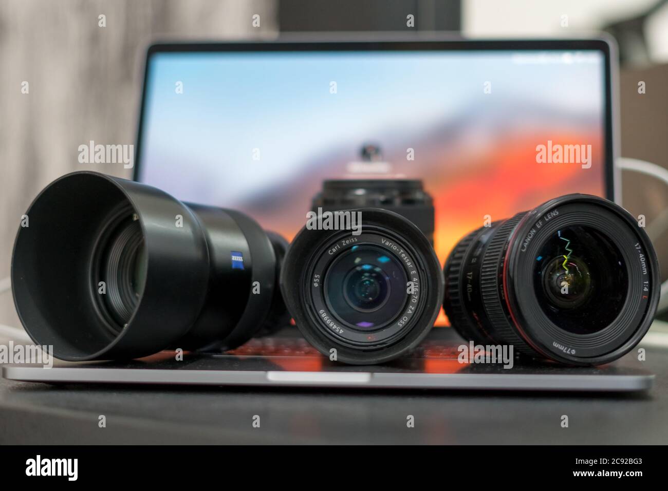 Digital camera, lens and laptop. concept of photographer work station ...