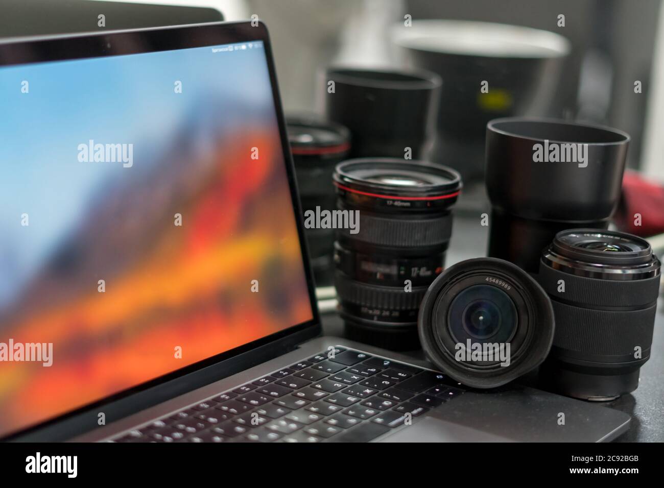 Digital camera, lens and laptop. concept of photographer work station ...
