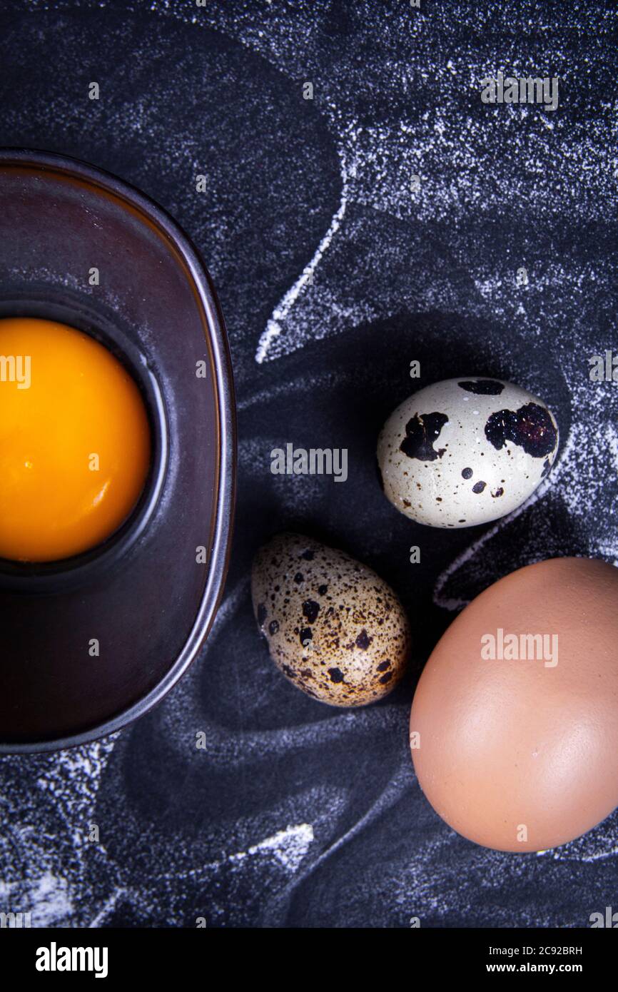 The quail egg is next to the native eggs and an egg yolk outside or ...