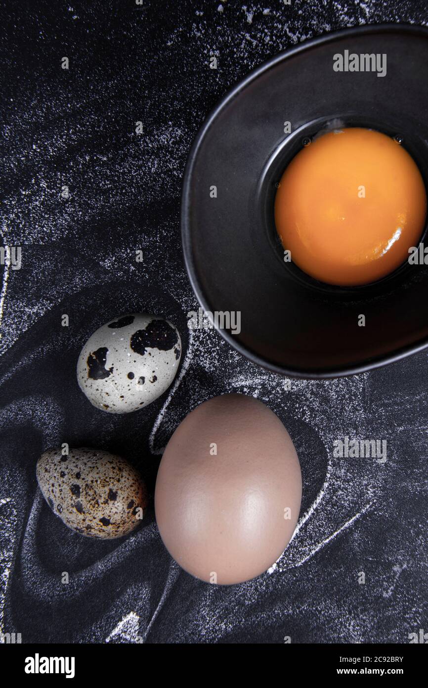 The quail egg is next to the native eggs and an egg yolk outside or ...