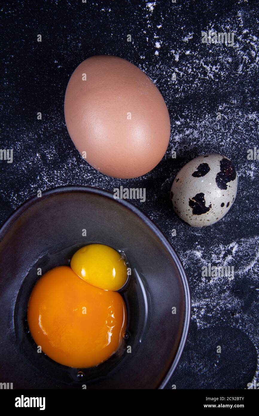 The quail egg is next to the native eggs and an egg yolk outside or ...