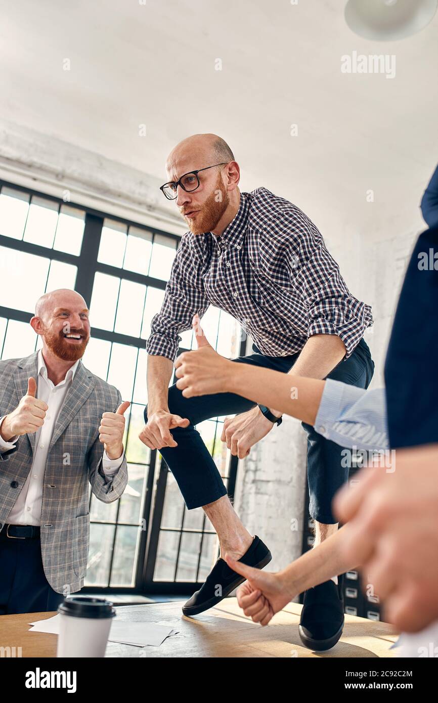 Excited diverse business team employees screaming celebrating good news business win corporate ...