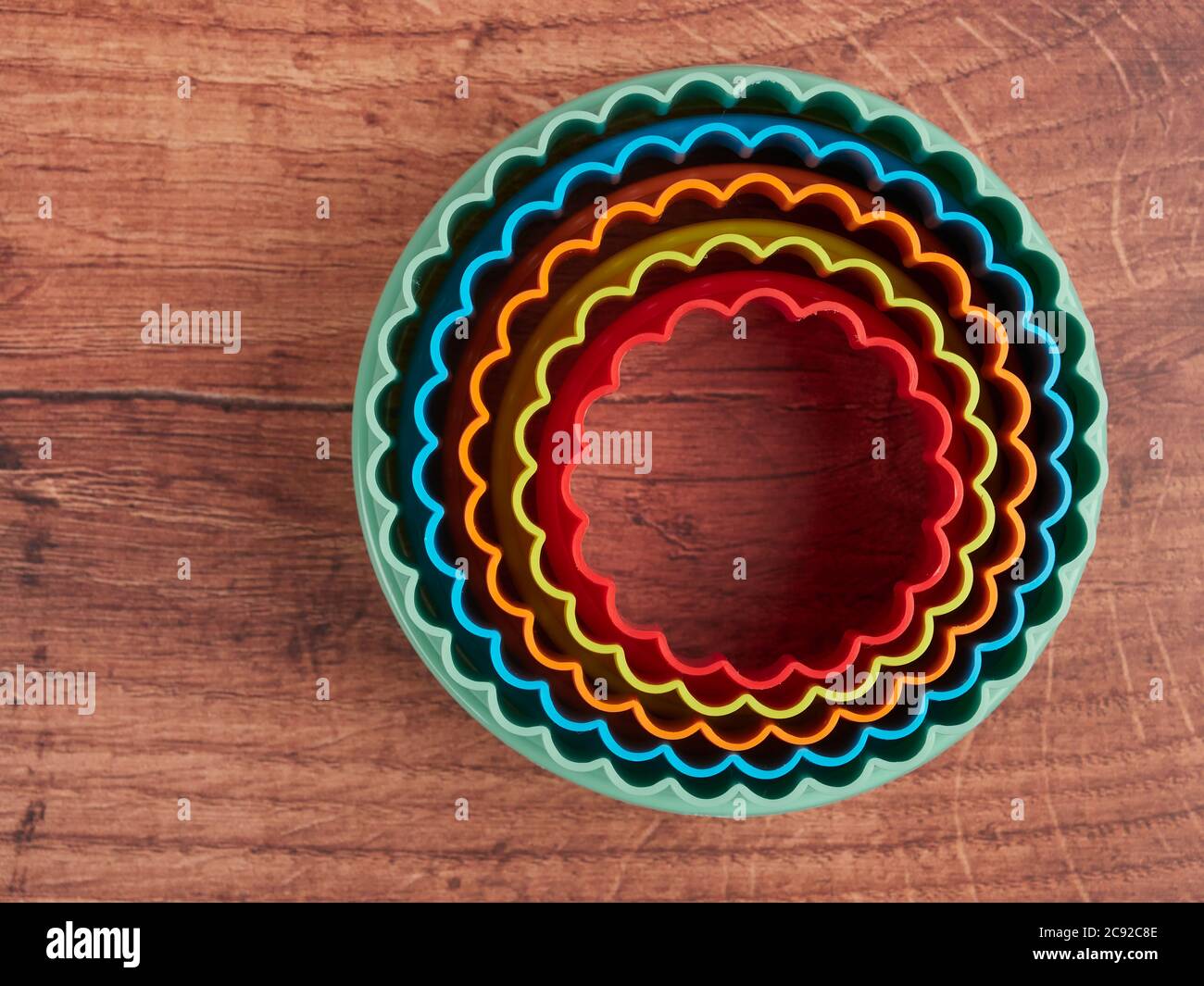 Colorful cookie cutters on wood background Stock Photo - Alamy