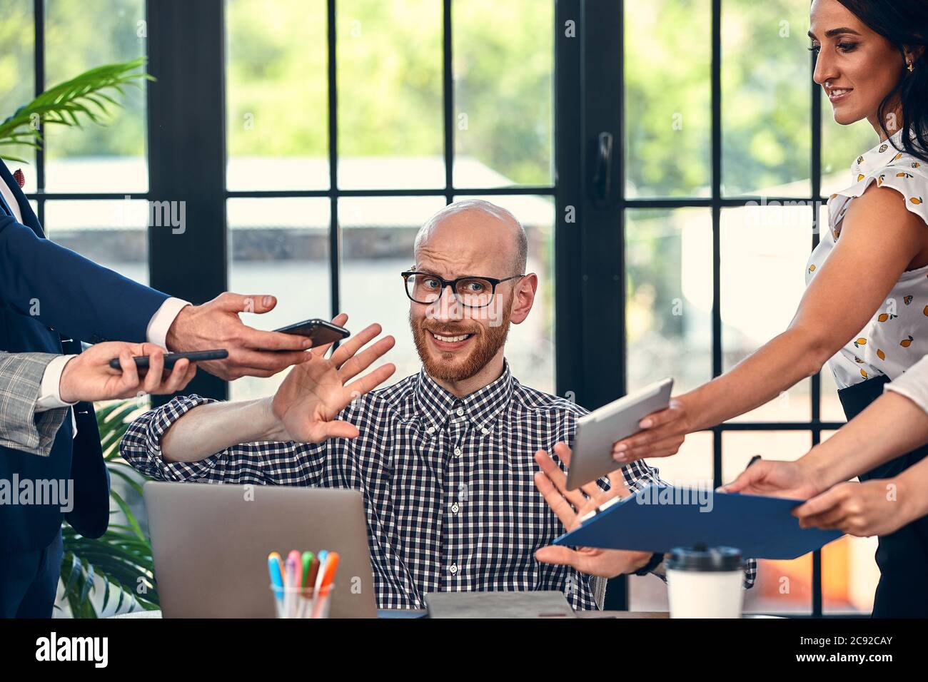 Tired man being overloaded at work. Too many work Stock Photo - Alamy