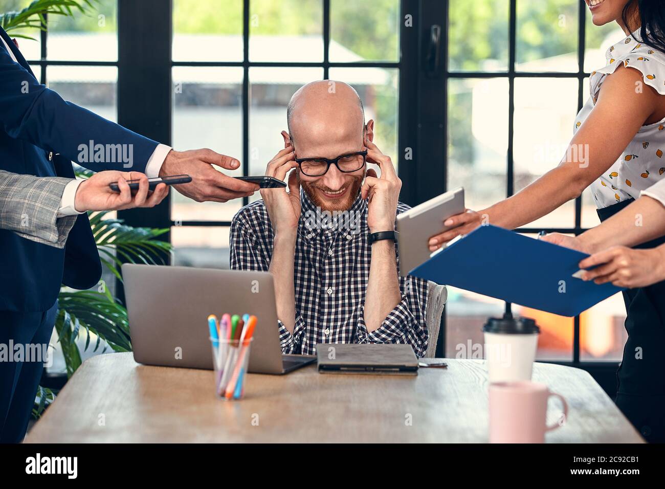Tired man being overloaded at work. Too many work Stock Photo - Alamy