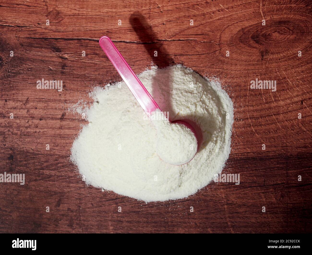 A heap of organic milk formula for infants, with measuring spoon, on ...
