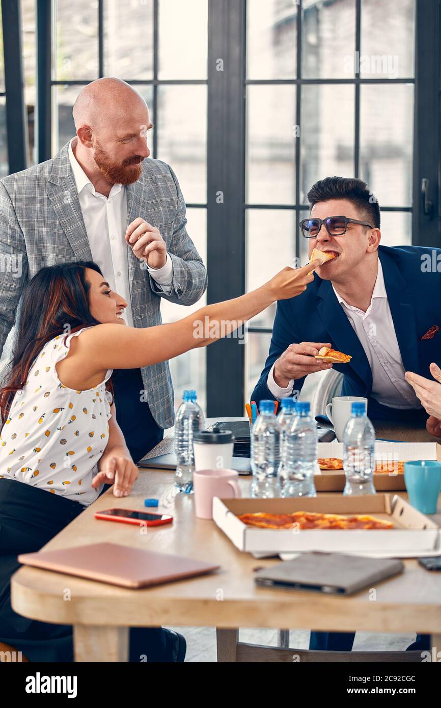 Happy business team eating pizza in office.Business,food, lunch and ...