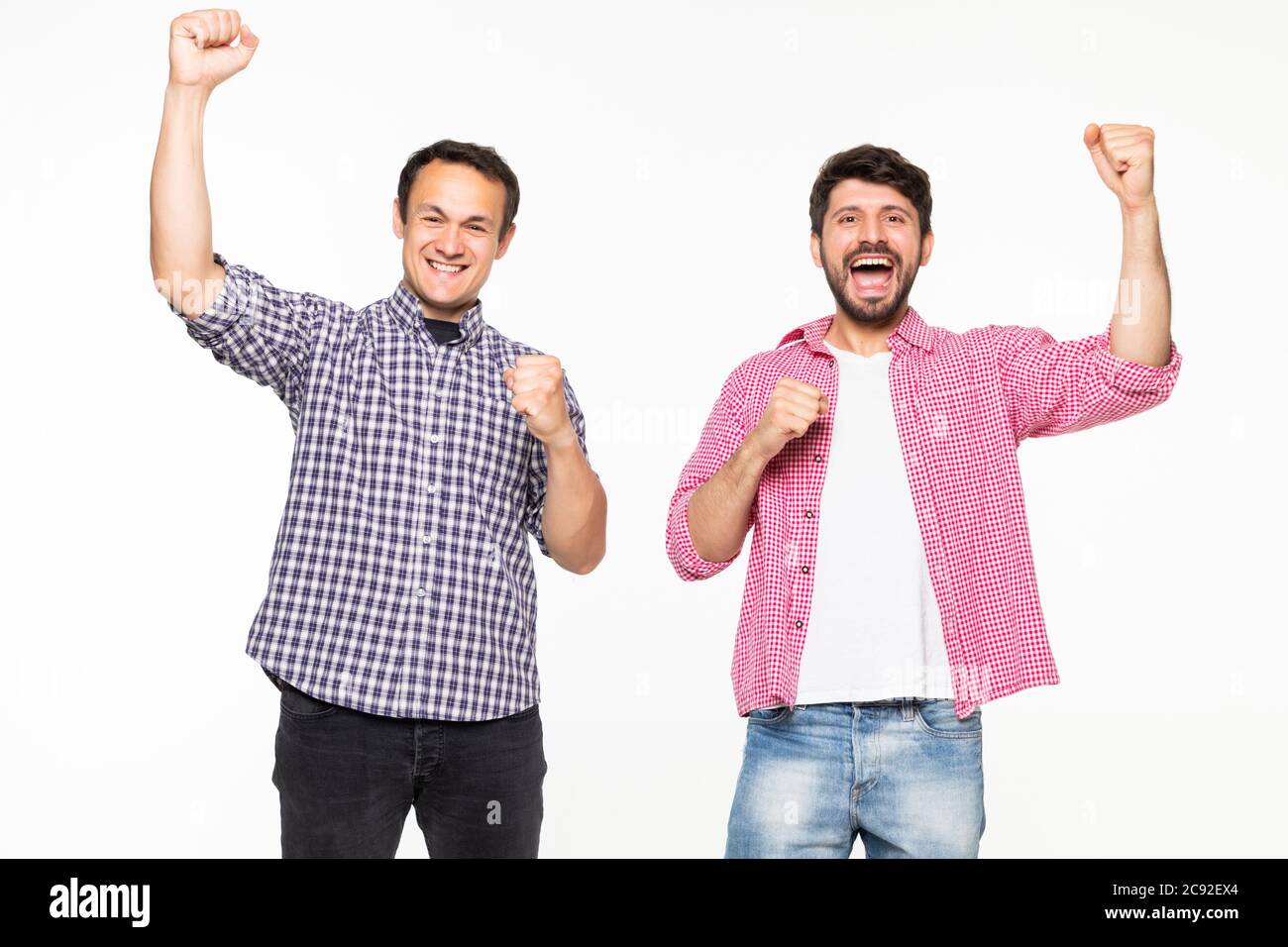 Portrait of a two cheerful men celebrating isolated over white ...