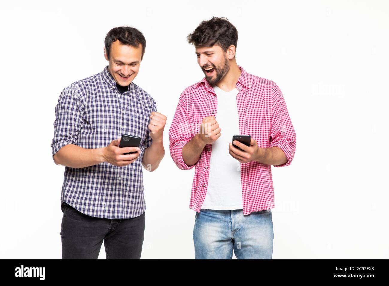 Young men holding mobile phones hi-res stock photography and images - Alamy