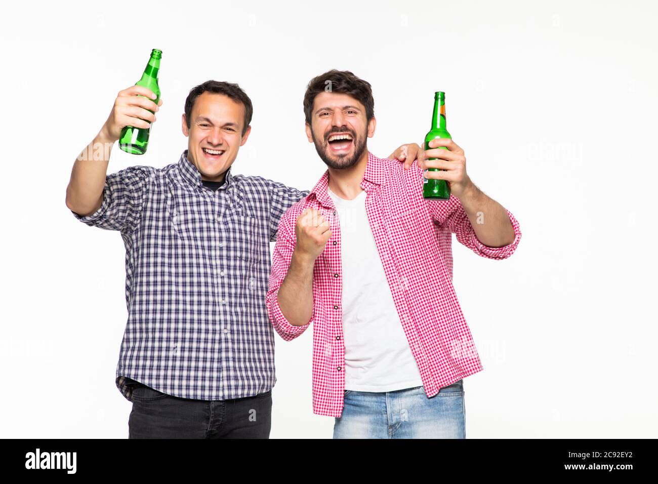 Portrait of a two excited young men best friends toasting with beer ...