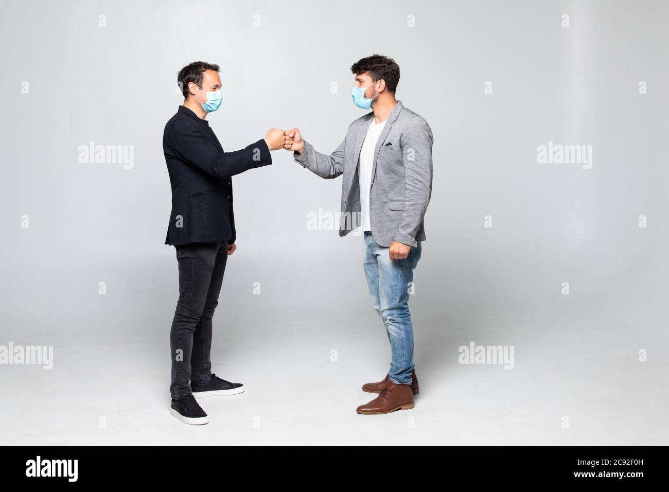 Fist bump greeting. Two people in suits greet each other in a meeting ...