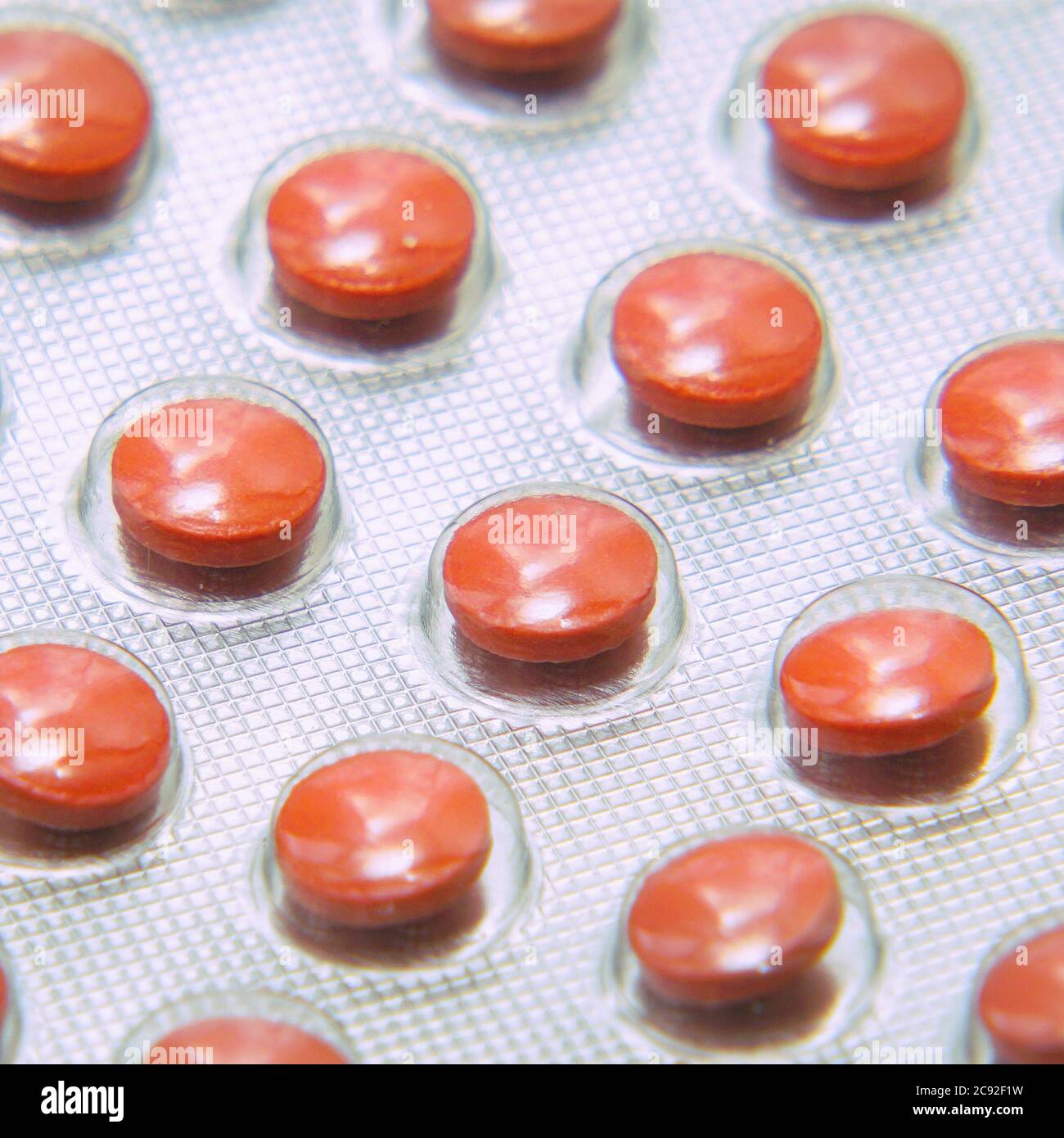 Blister with tablets close-up on a gray background. Pharmaceutical or ...