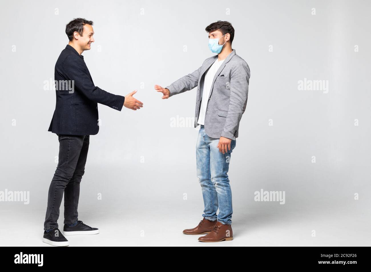 Two people in suits refuse to greet each other in a meeting traditional ...