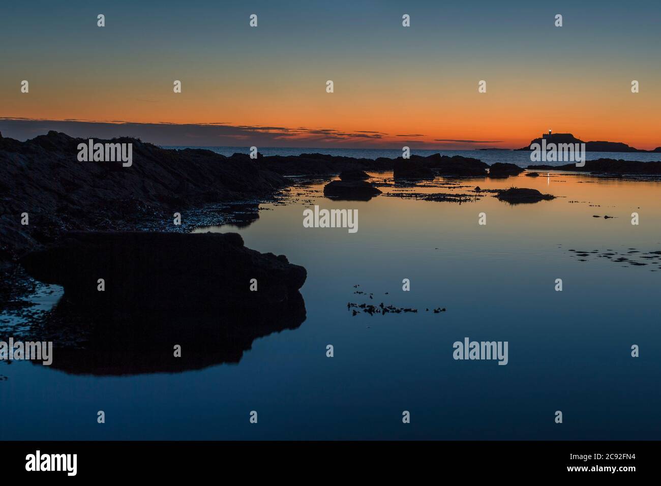 An early morning sunrise is seen over the fortress of solitude beach of ...