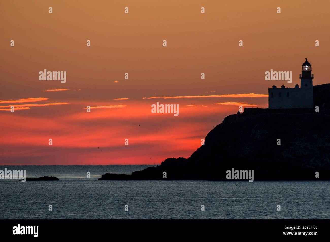 An early morning sunrise is seen over the fortress of solitude beach of ...