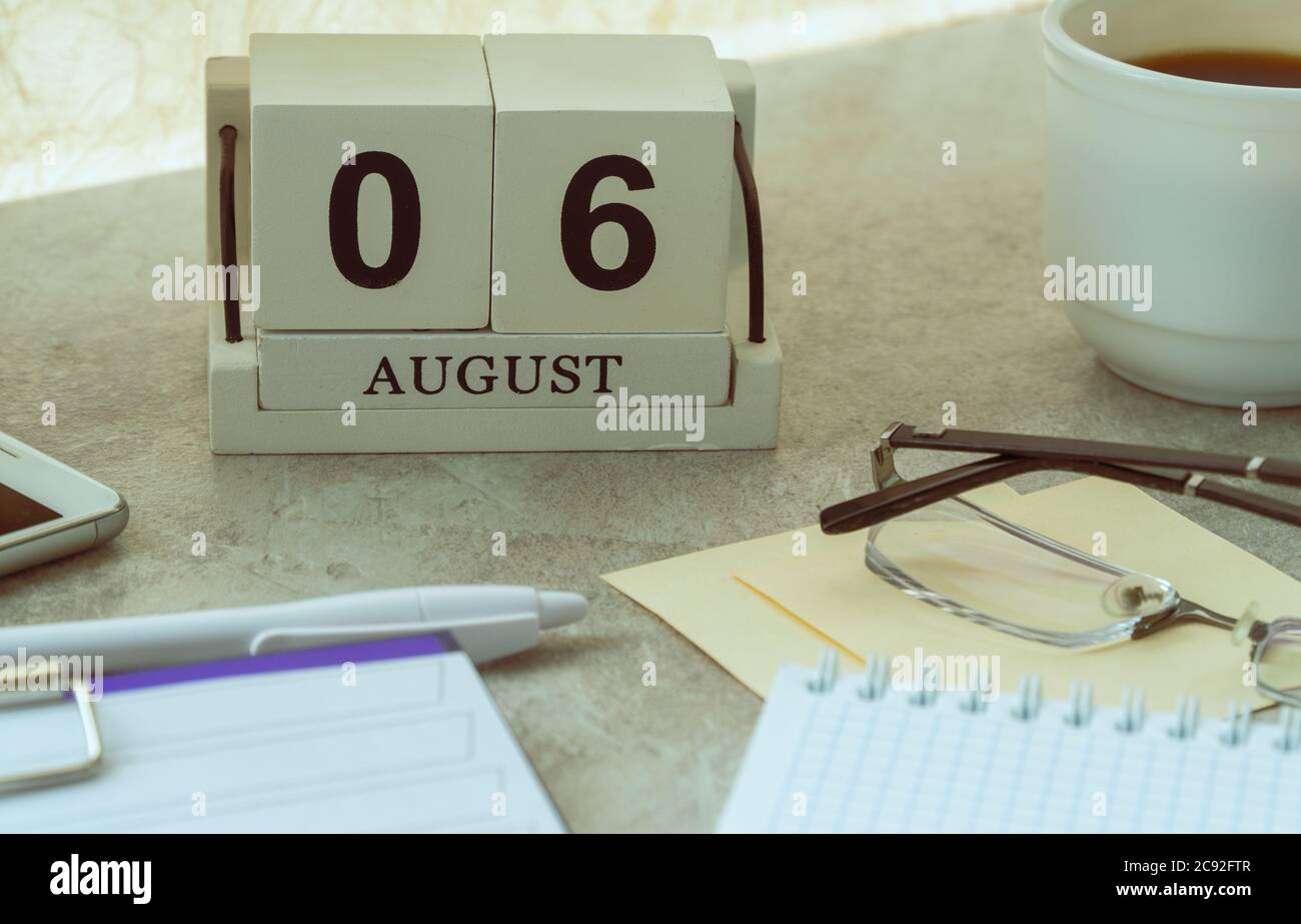 August 06, date on the calendar. Handmade wood cube with date month and ...